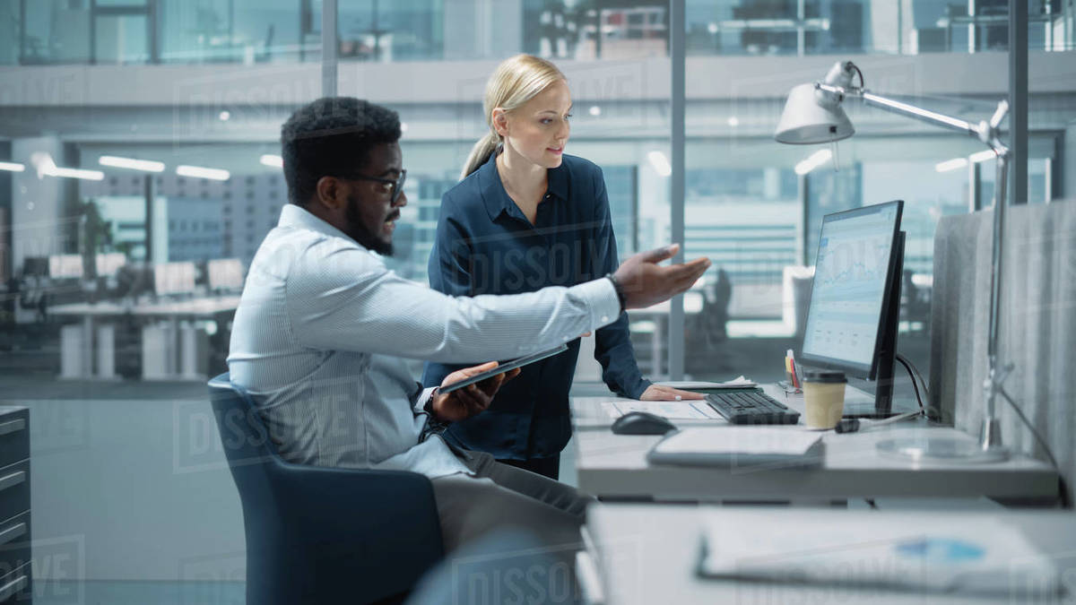 Diverse Team of Managers Working and Having Discussions in Modern Big ...