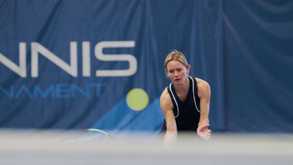 Female Tennis Player Hitting Ball with a Racquet During Championship ...
