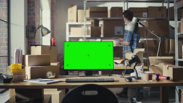 Desktop Computer Monitor Standing on a Table with a Green Screen ...