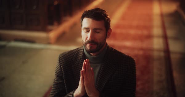 Young Christian Man on his Knees in Church, with Folded Hands He Seeks ...
