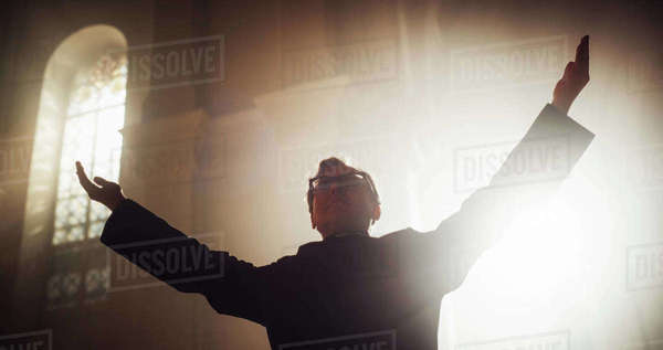 Portrait of Christian Priest Raising Hands In Blessing His Congregation ...