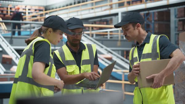 Diverse Team Of Warehouse Workers Having A Meeting In Logistics ...