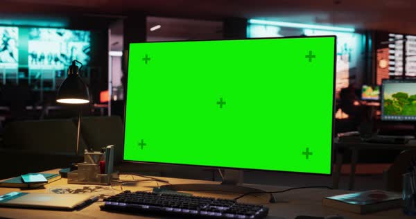 Computer Monitor with Green Screen Standing on a Wooden Desk with ...
