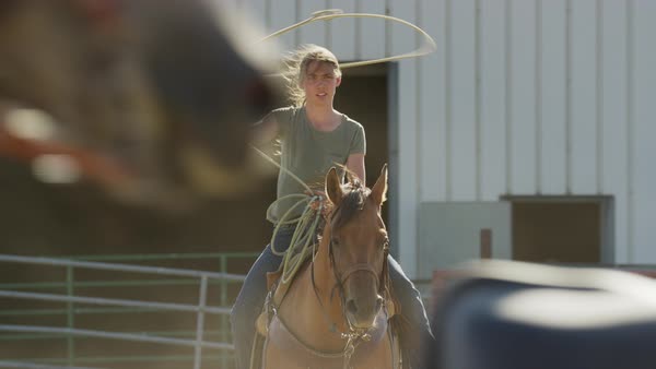 Medium slow motion shot of girl spinning lasso on horse - 4K Rights ...