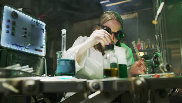 Mad scientist mixing substance with liquid in laboratory - 4K Rights ...