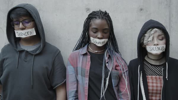 Close up of quiet silenced protesters with tape covering mouths / Provo ...