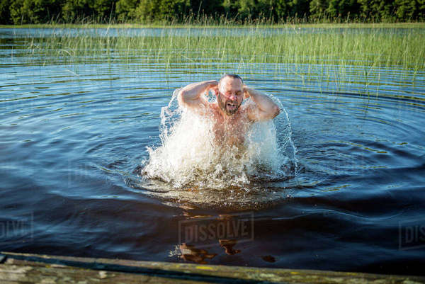 Man swimming in lake - Stock Photo - Dissolve