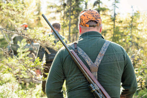 Hunters in forest - Stock Photo - Dissolve