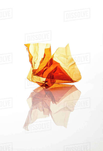 Creased piece of paper on white background - Stock Photo - Dissolve