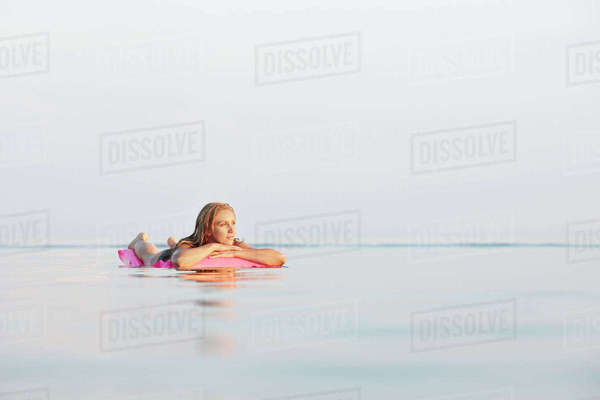 Woman floating on inflatable mattress - Royalty-free Stock Photo | Dissolve