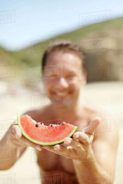 Man holding watermelon - Royalty-free Stock Photo | Dissolve