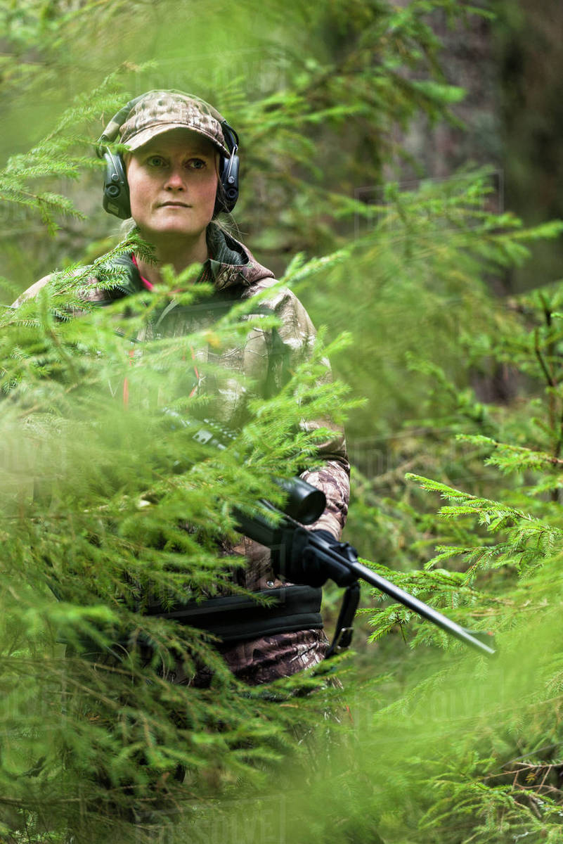 Woman hunting in forest - Royalty-free Stock Photo | Dissolve