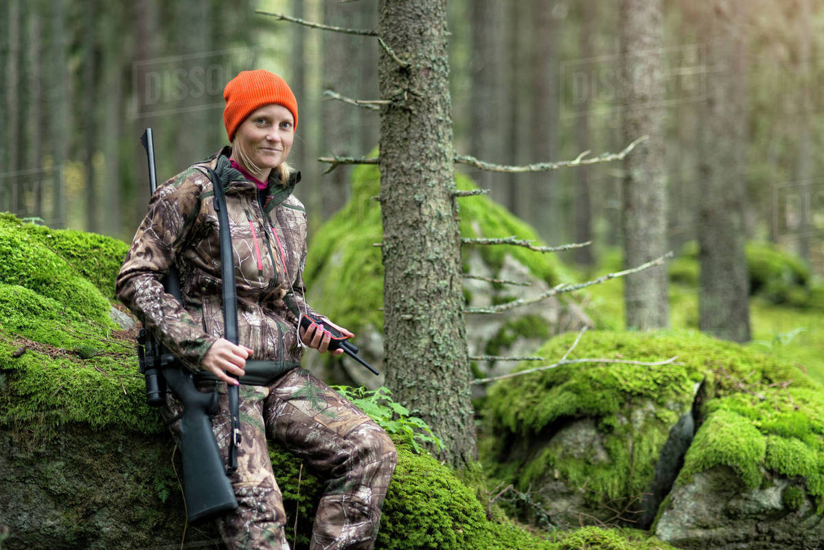 Woman hunting in forest - Royalty-free Stock Photo | Dissolve