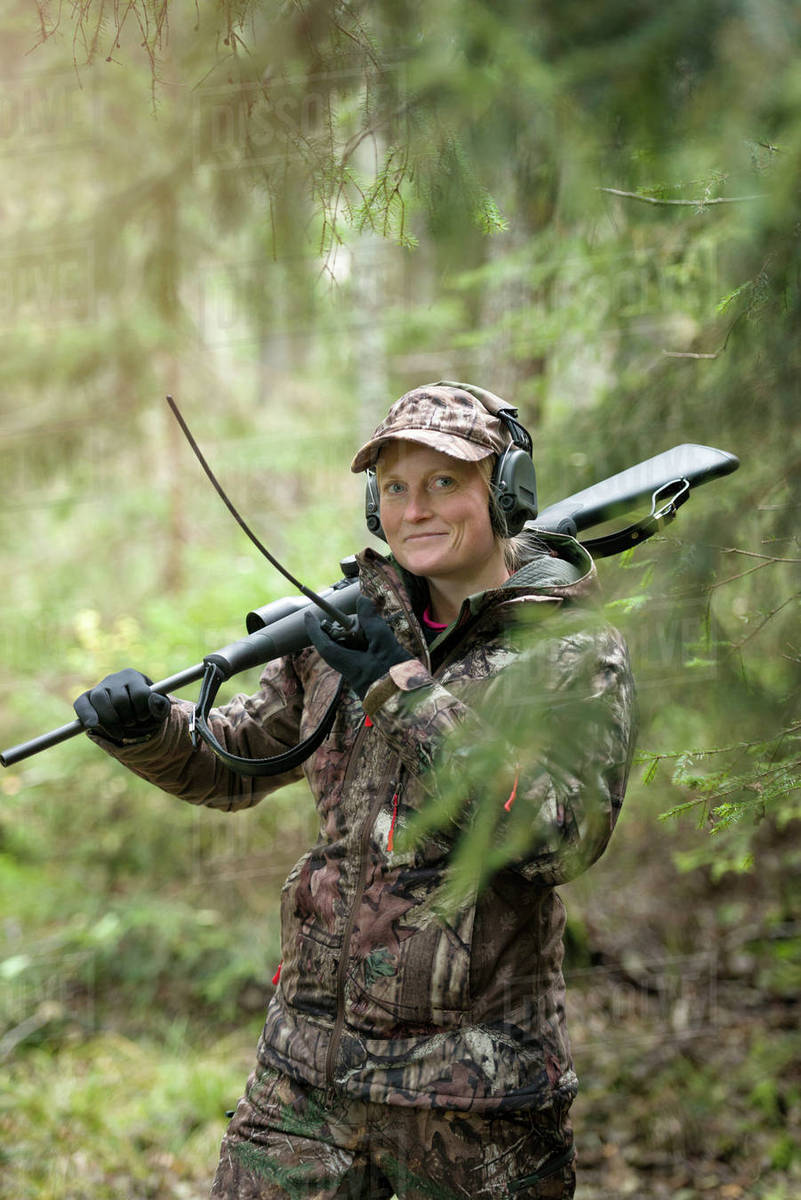 Woman hunting in forest - Royalty-free Stock Photo | Dissolve