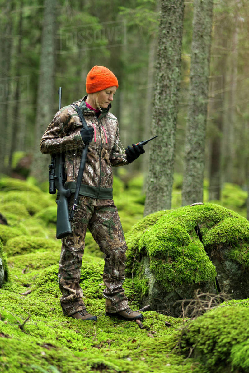 Woman hunting in forest - Royalty-free Stock Photo | Dissolve