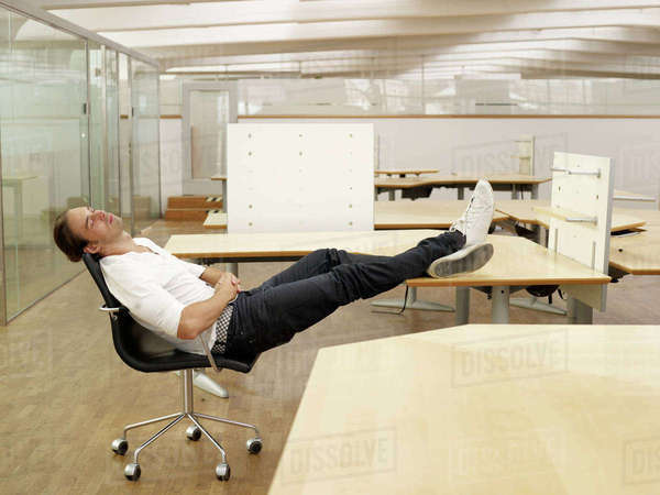 Man sleeping in empty office - Royalty-free Stock Photo | Dissolve