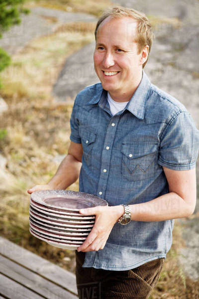 Man carrying plates - Royalty-free Stock Photo | Dissolve