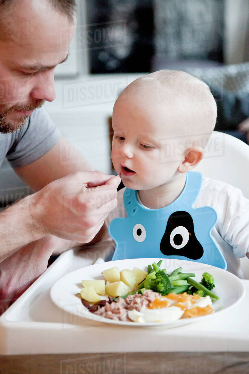Father feeding baby boy - Royalty-free Stock Photo | Dissolve