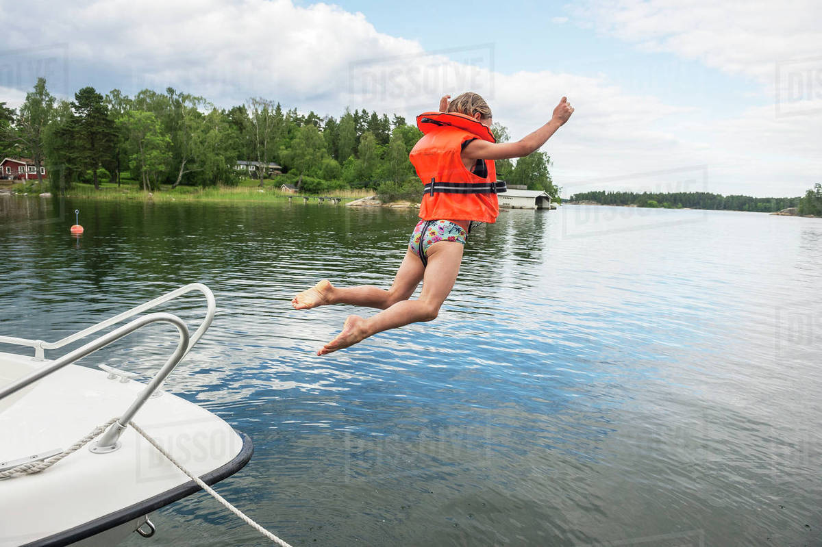 Girl jumping into water - Royalty-free Stock Photo | Dissolve
