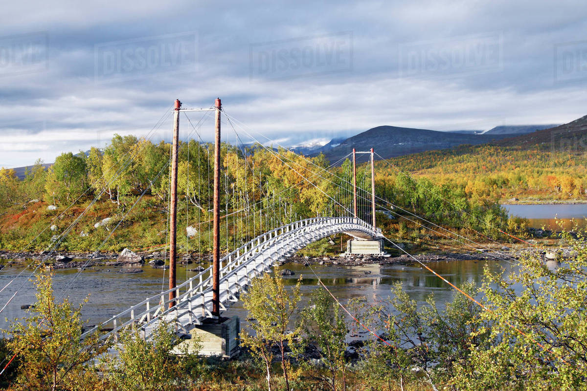 Footbridge above river - Stock Photo - Dissolve