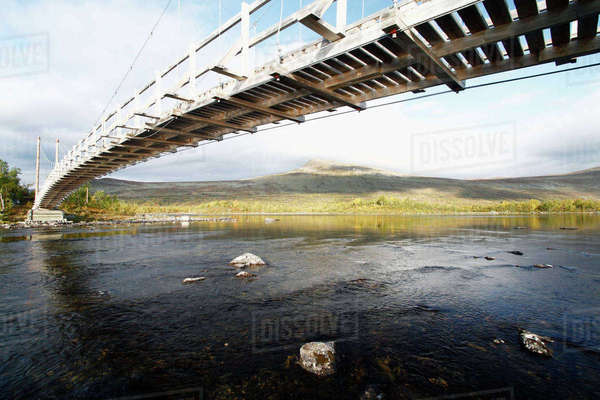 Footbridge above river - Stock Photo - Dissolve
