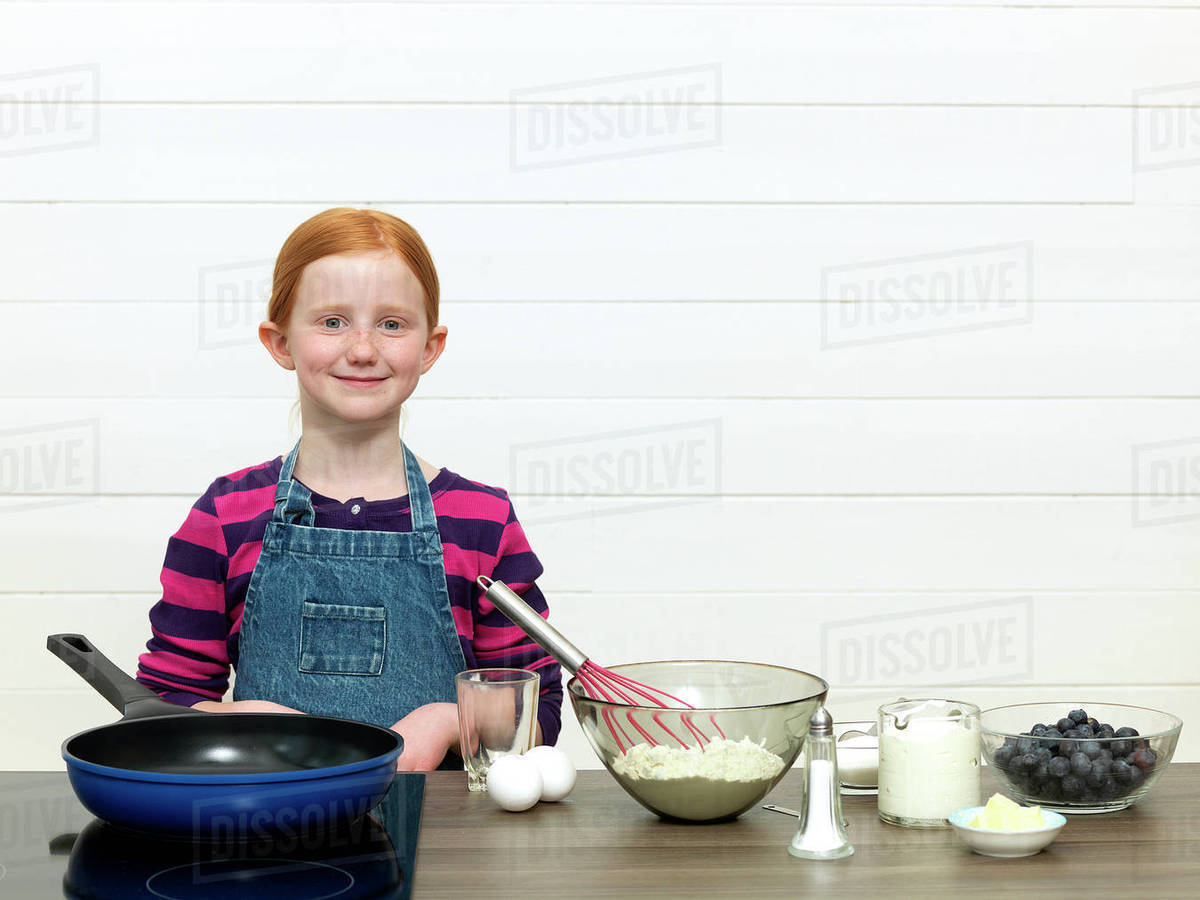 Smiling girl cooking - Royalty-free Stock Photo | Dissolve