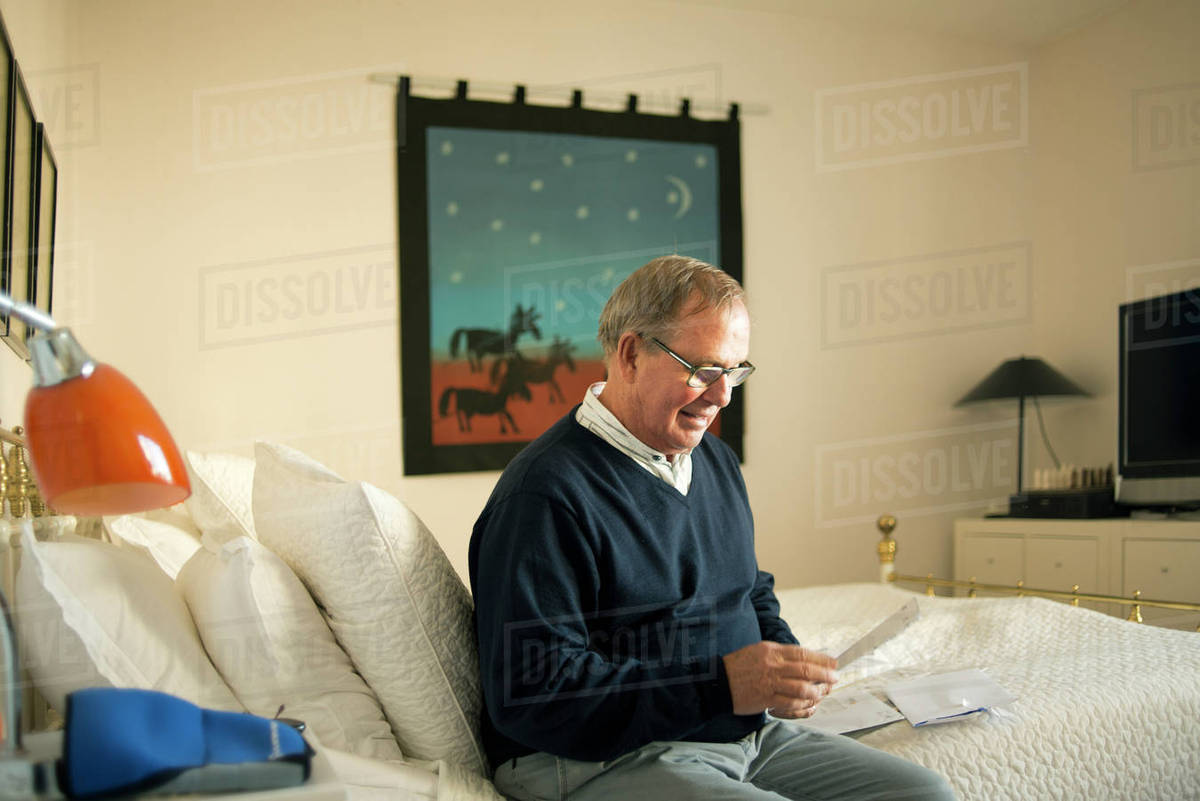 Senior man reading letter - Stock Photo - Dissolve