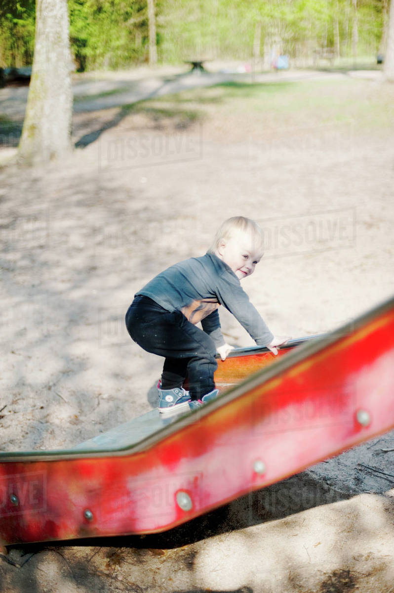 Boy on slide at playground - Royalty-free Stock Photo | Dissolve