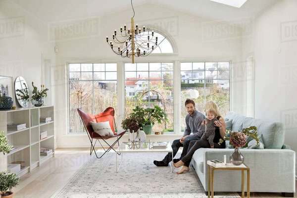 Family in modern living room - Royalty-free Stock Photo | Dissolve