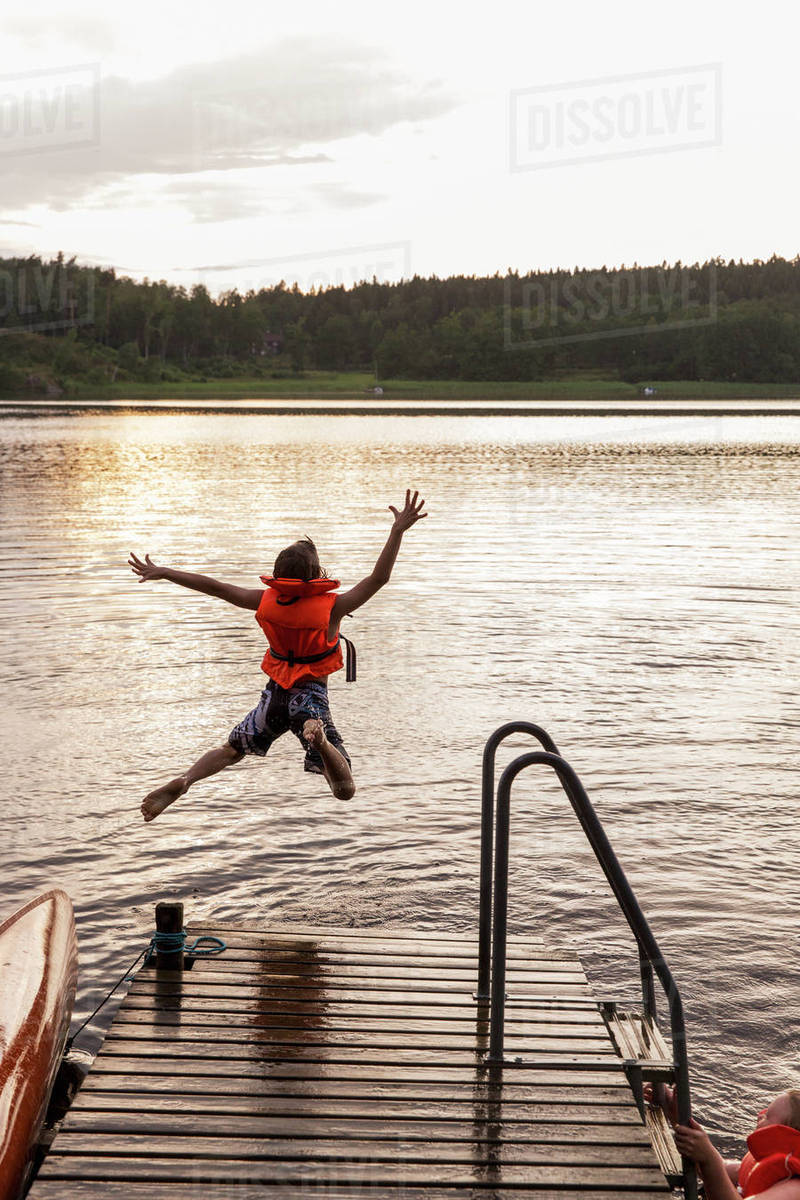 Child jumping into water - Stock Photo - Dissolve