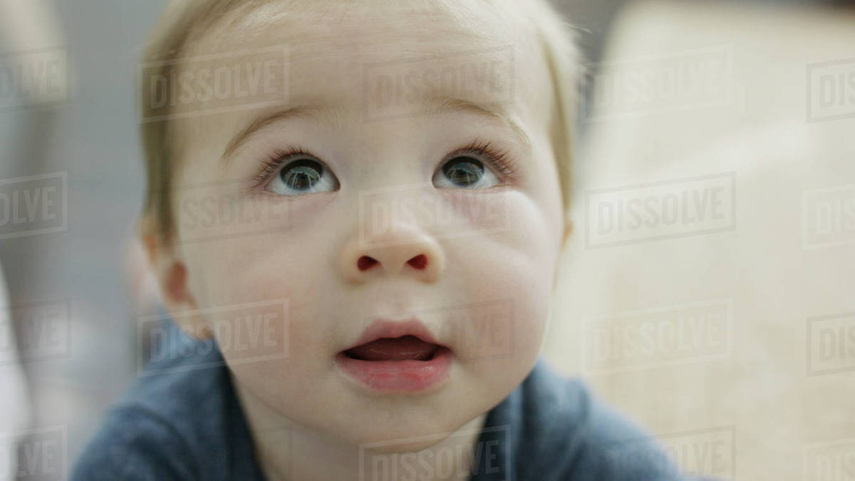Close up of adorable inquisitive baby boy looking up - Stock Photo ...