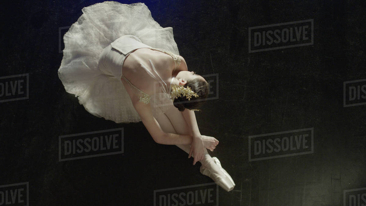 High angle view of performing dancer ballerina in tutu and toe shoes ...
