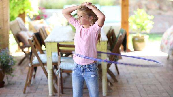 9 year old girl using a hula hoop on outdoor patio - Stock Video ...