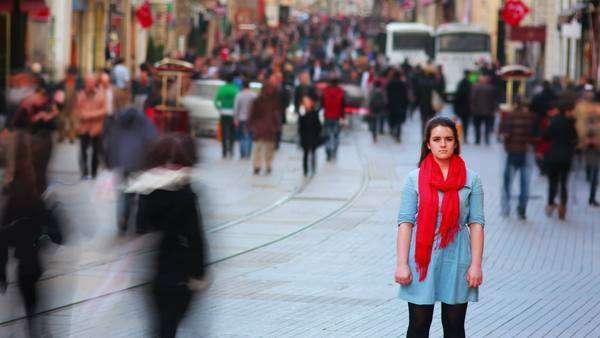 Young woman posing, busy street, people walking around, 4K, close up ...