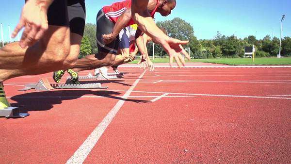 Slow motion of sprinters in business suits at 100 meter start - Stock ...