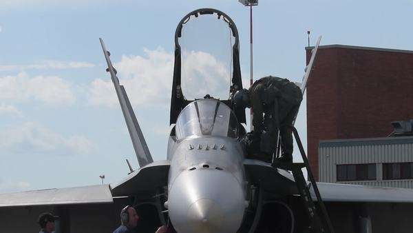 Pilot exits F18 fighter jet with bag, climbs down boarding ladder. - HD ...