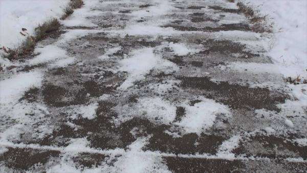 Sprinkled salt melts snow in timelapse. - Stock Video Footage - Dissolve