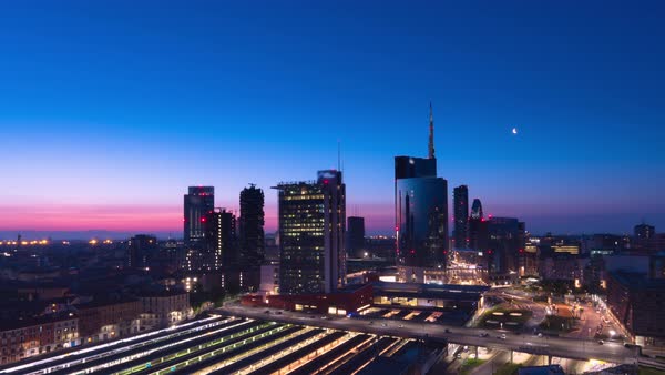 Milan skyline timelapse at sunrise sun rising over business area ...