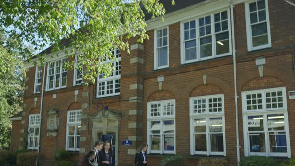 Young students entering school building at the beginning of the day ...