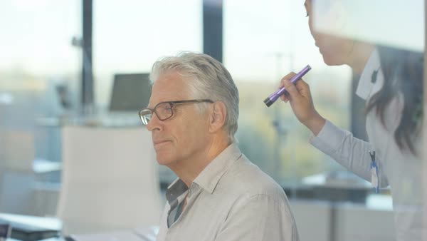 Audiology doctor examining a patient and explaining about hearing loss ...
