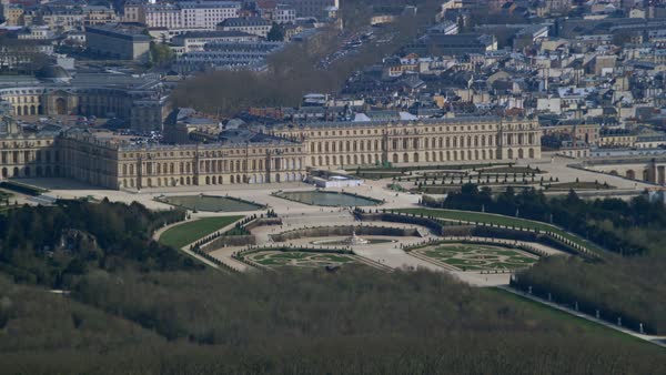 Aerial view above the palace of Versailles with landscaped gardens and ...