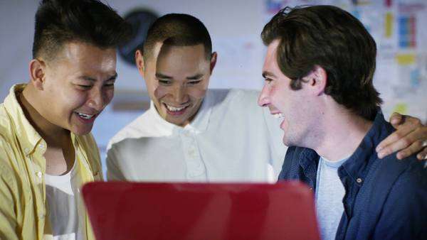 Happy male computer programmers working together give a high five. - 4K ...