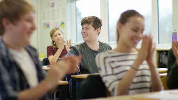 Young boy talking in school classroom gets round of applause from the ...