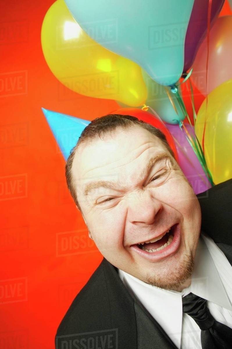 Man With Balloons - Stock Photo - Dissolve