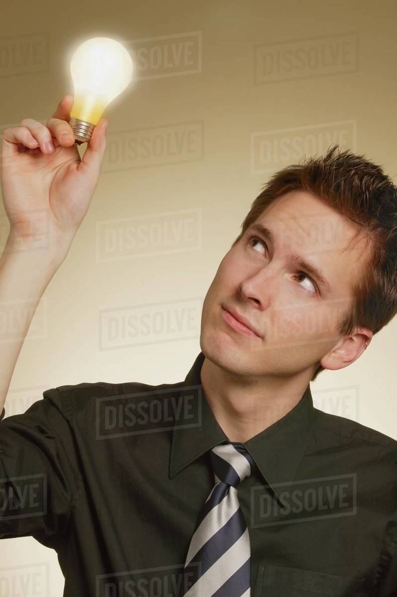 Man With A Light Bulb - Stock Photo - Dissolve