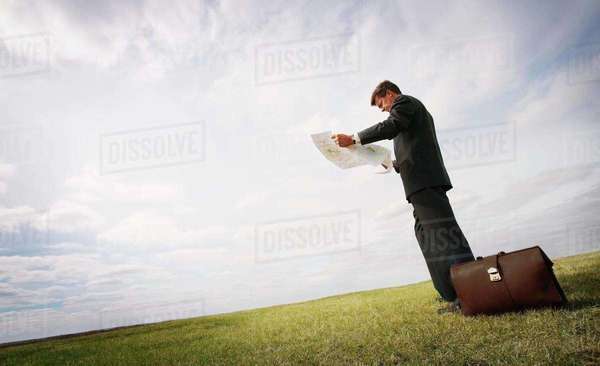 Man Looking At A Plan - Stock Photo - Dissolve