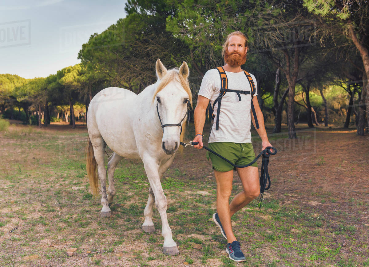 A man walking with a white horse; Cadiz, Andalusia, Spain - Royalty ...