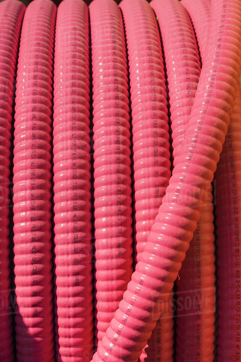 Close up of a red ribbed hose at an electrical power plant, Prudhoe Bay ...