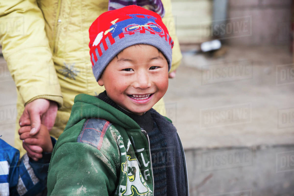 Smiling Tibetan Child On A Street; Gade City, Qinghai Province, Tibet ...