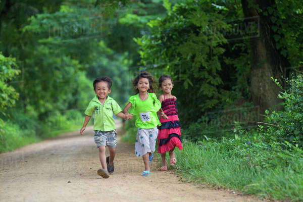 Young Children Running Down A Dirt Road; Battambang, Cambodia - Stock ...